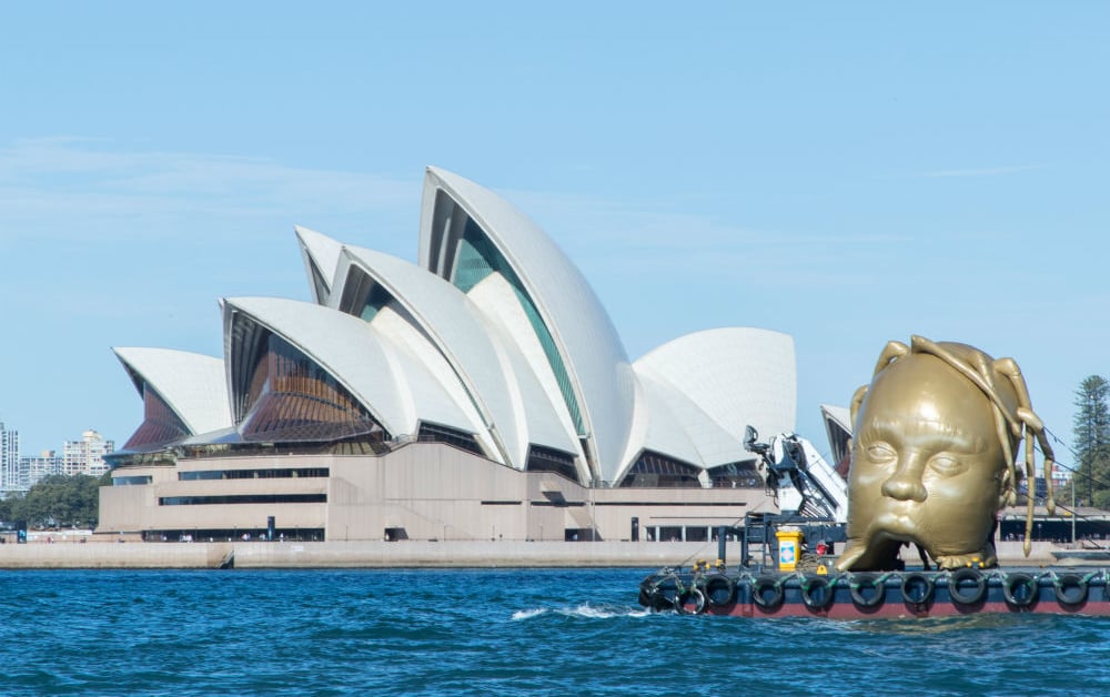 Giant Travis Scott inflatable head sails in Sydney Harbour
